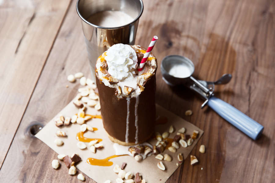 A candy bar milkshake in a cup made of homemade Snickers - Thrillist ...
