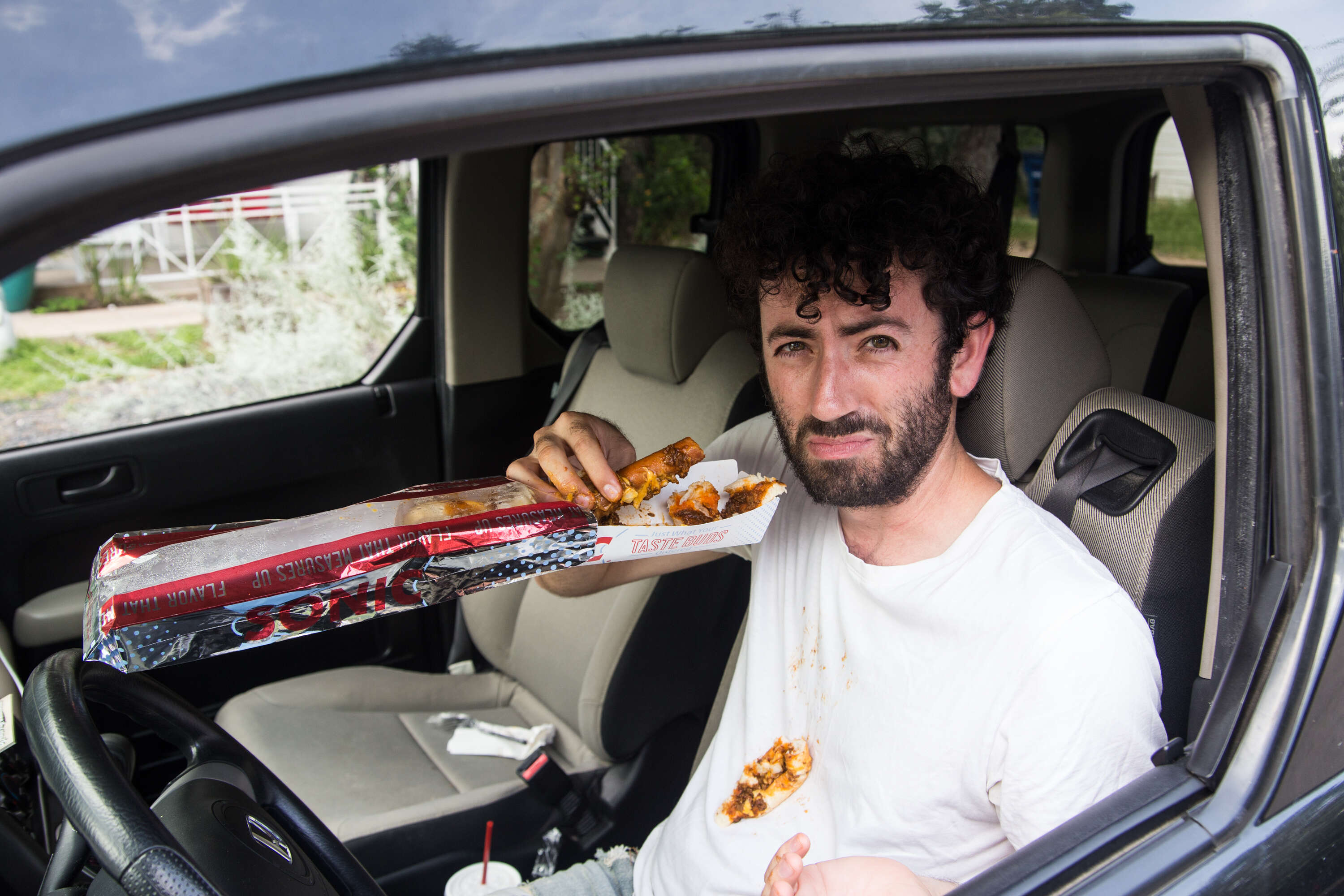 Man Eating Fast Food In A Car