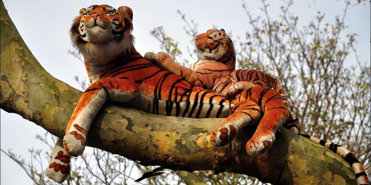 Toy Tigers Keep Thieving Horde Of Monkeys At Bay - The Dodo