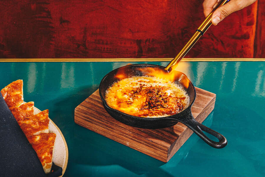 Sizzling and Flaming Cheese Dishes in Restaurants Are Popular Than Ever ...